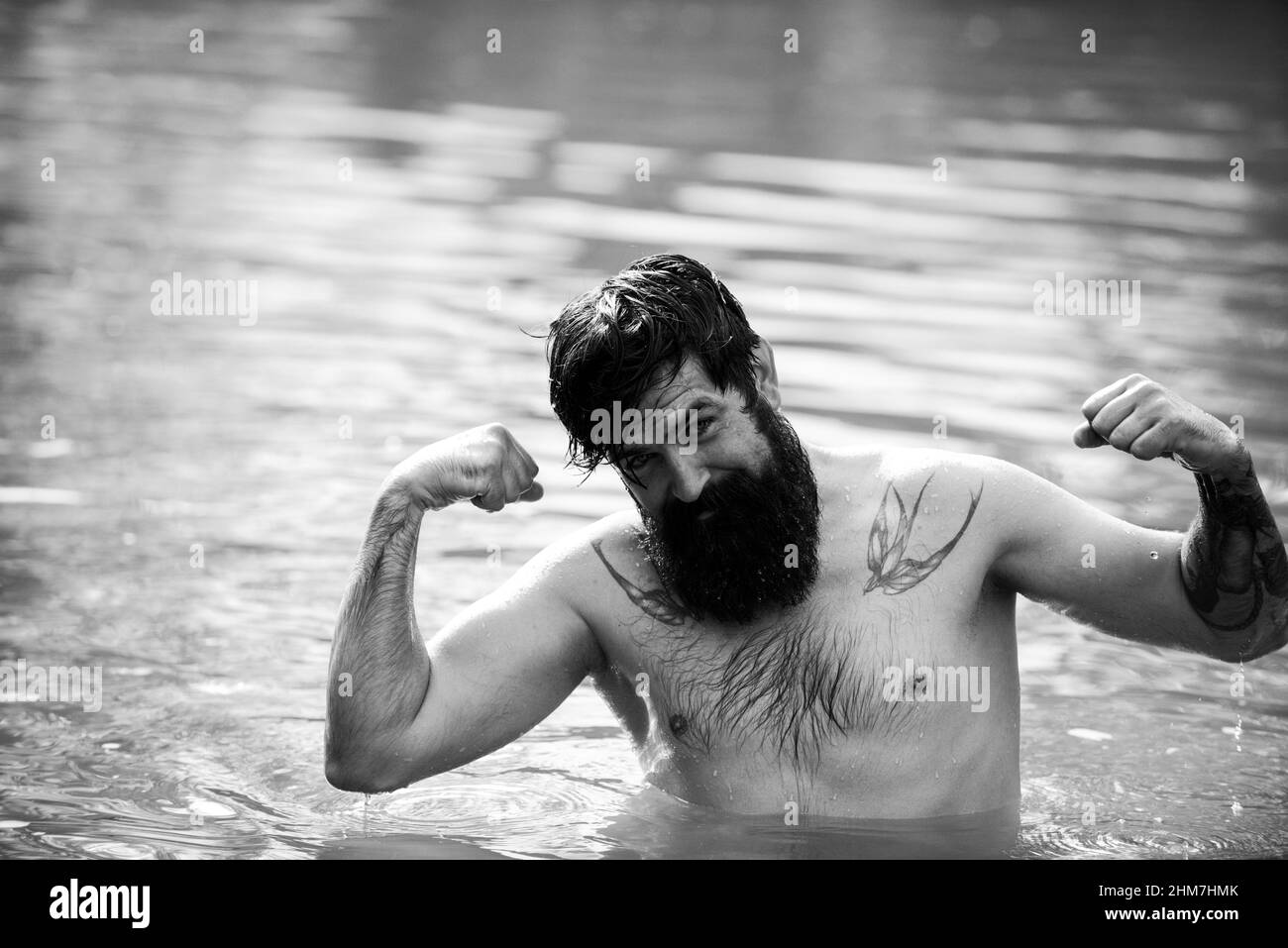 Bearded man on summer holidays. Male swimming in water. Having fun ...