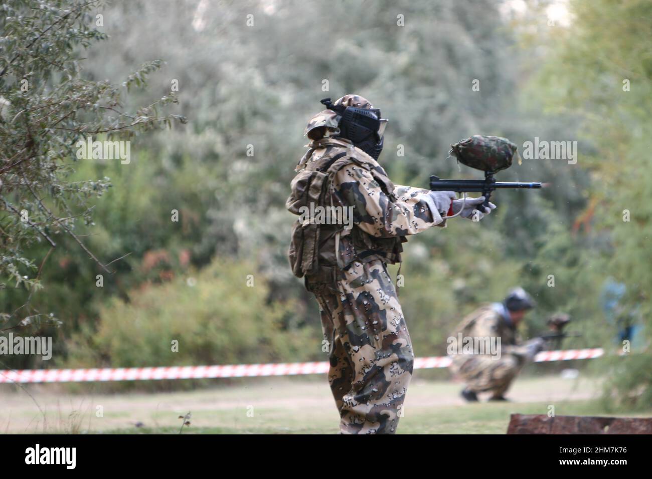 Man shooting a paintball gun Stock Photo - Alamy
