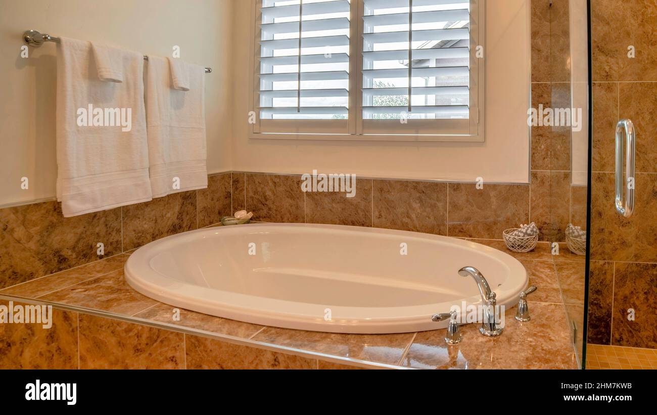 Panorama Bathroom interior with brilliant tan tiles and window Stock ...