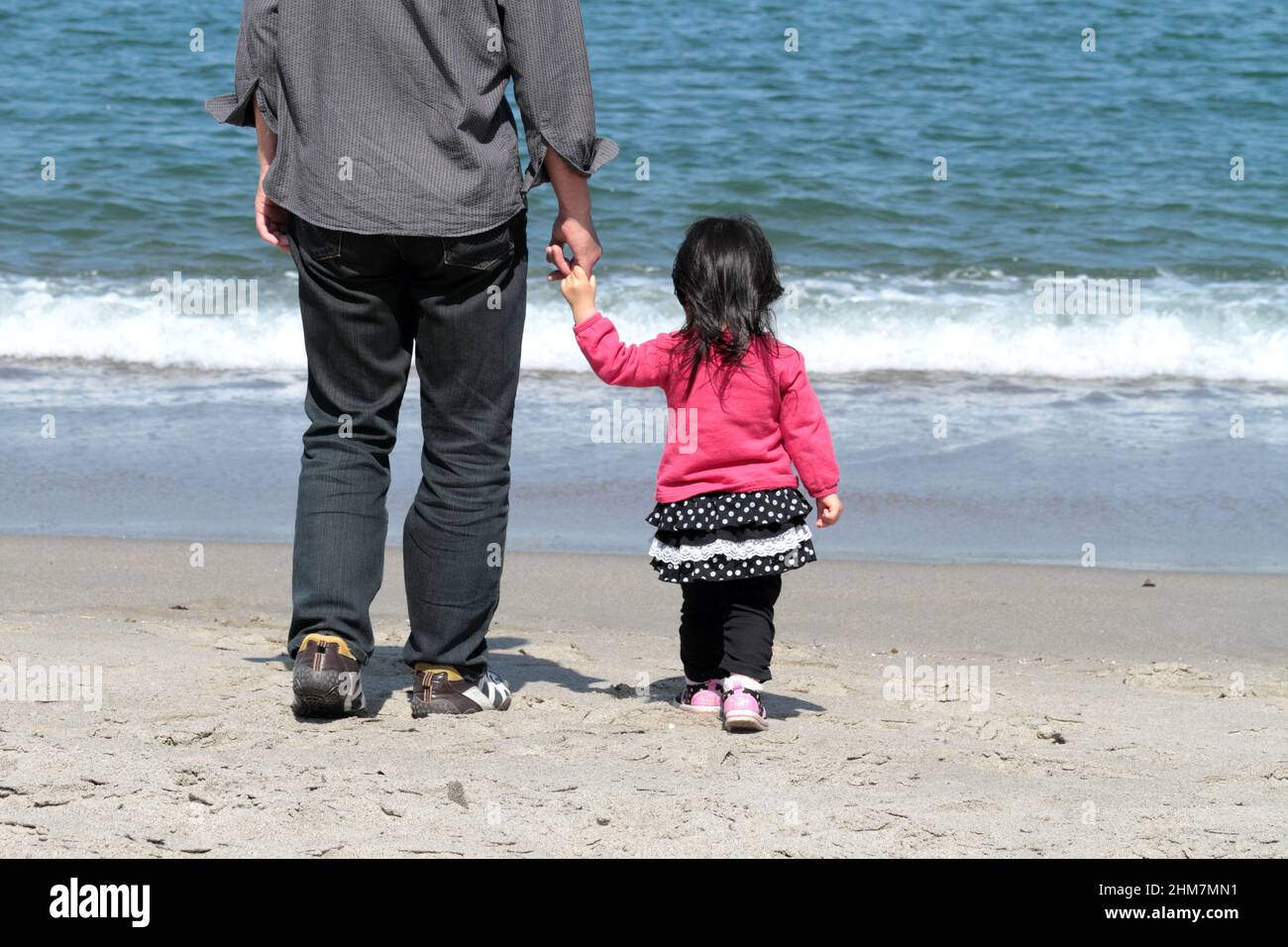 Child back view holding hands hi-res stock photography and images - Alamy