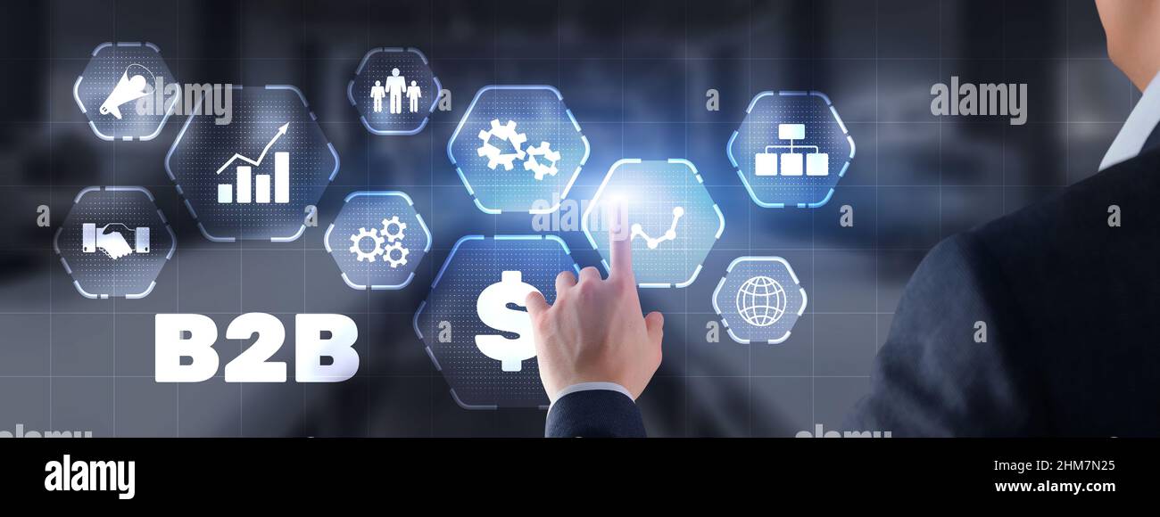 Businessman presses B2B icon on virtual screen on modern city ...