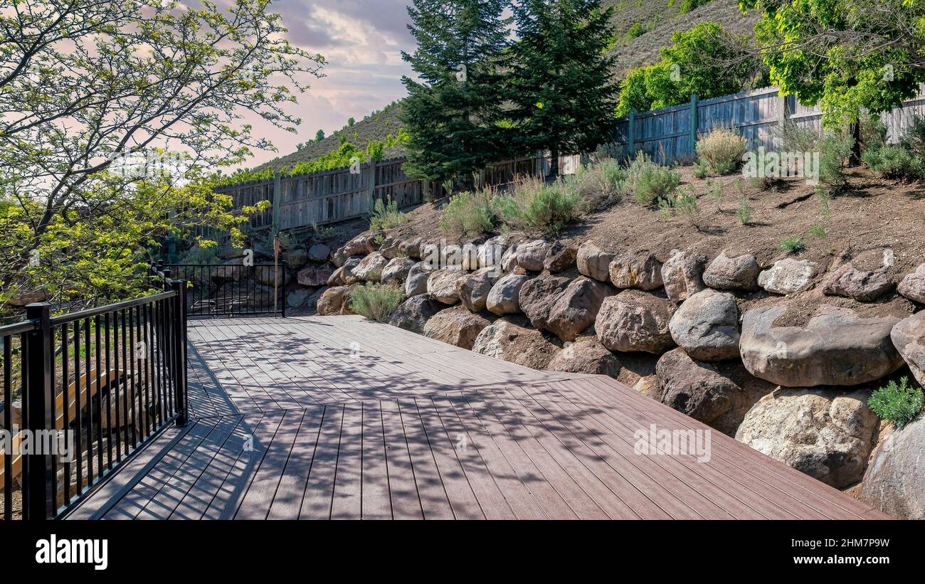 Panorama Puffy clouds at sunset Hillside wooden deck with metal ...
