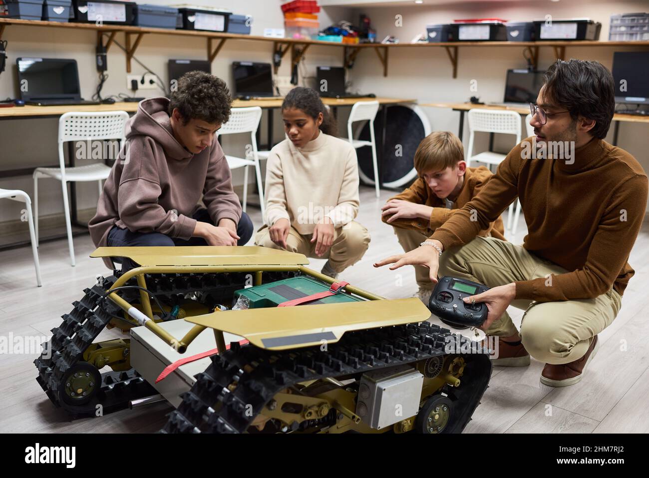 Full length portrait of diverse group of children looking at big ...