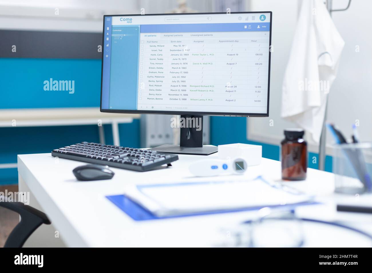 Computer with medical patients consultation document on screen standing ...