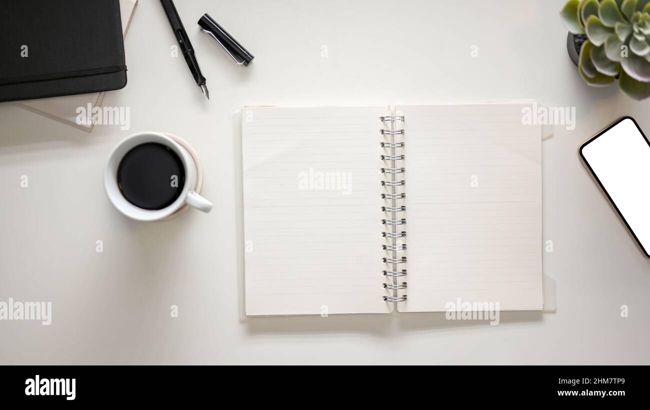 Overhead, Modern white workspace with coffee cup, stationery ...