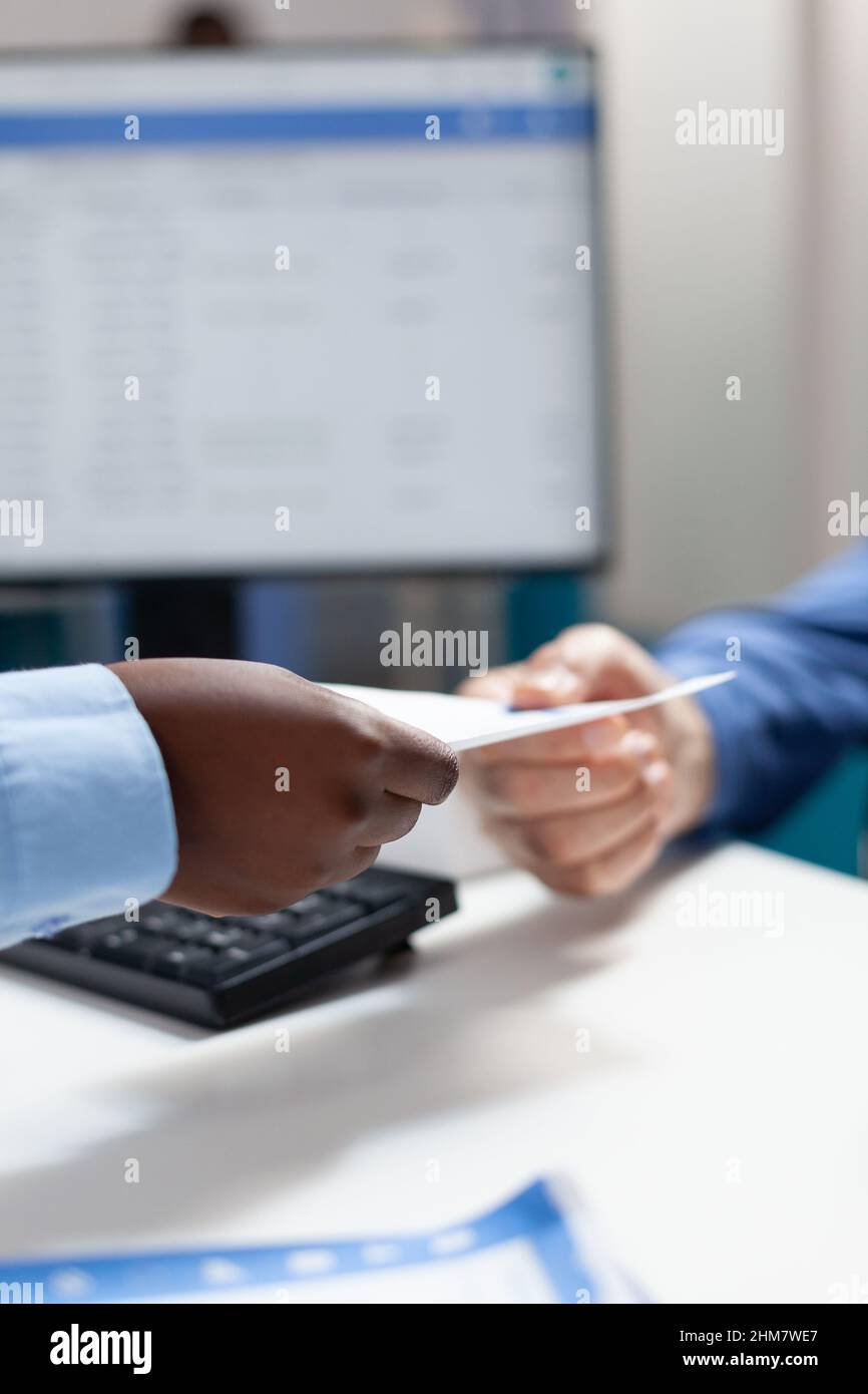 Doctor giving patient documents hi-res stock photography and images - Alamy