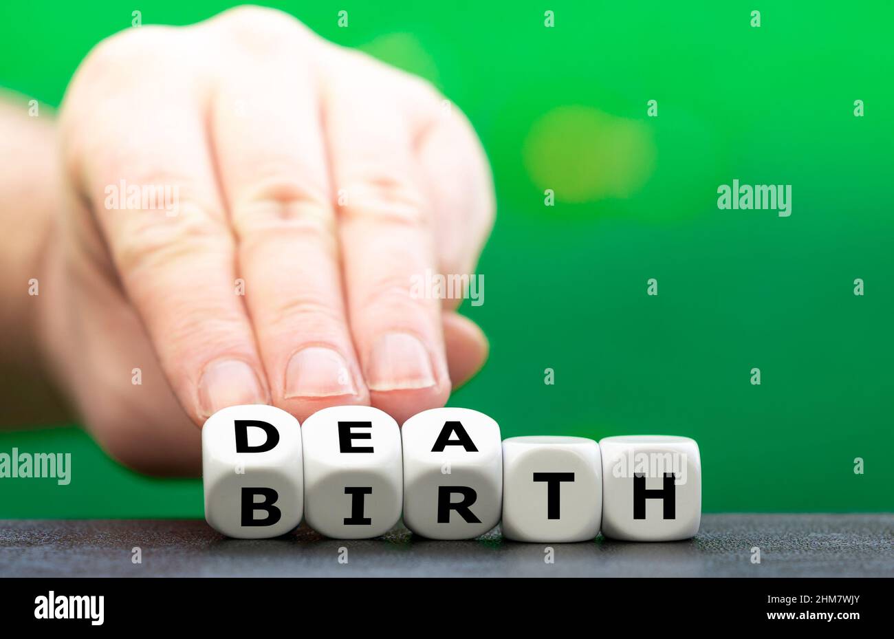 Symbol for the cycle of life. Hand turns dice and changes the word ...