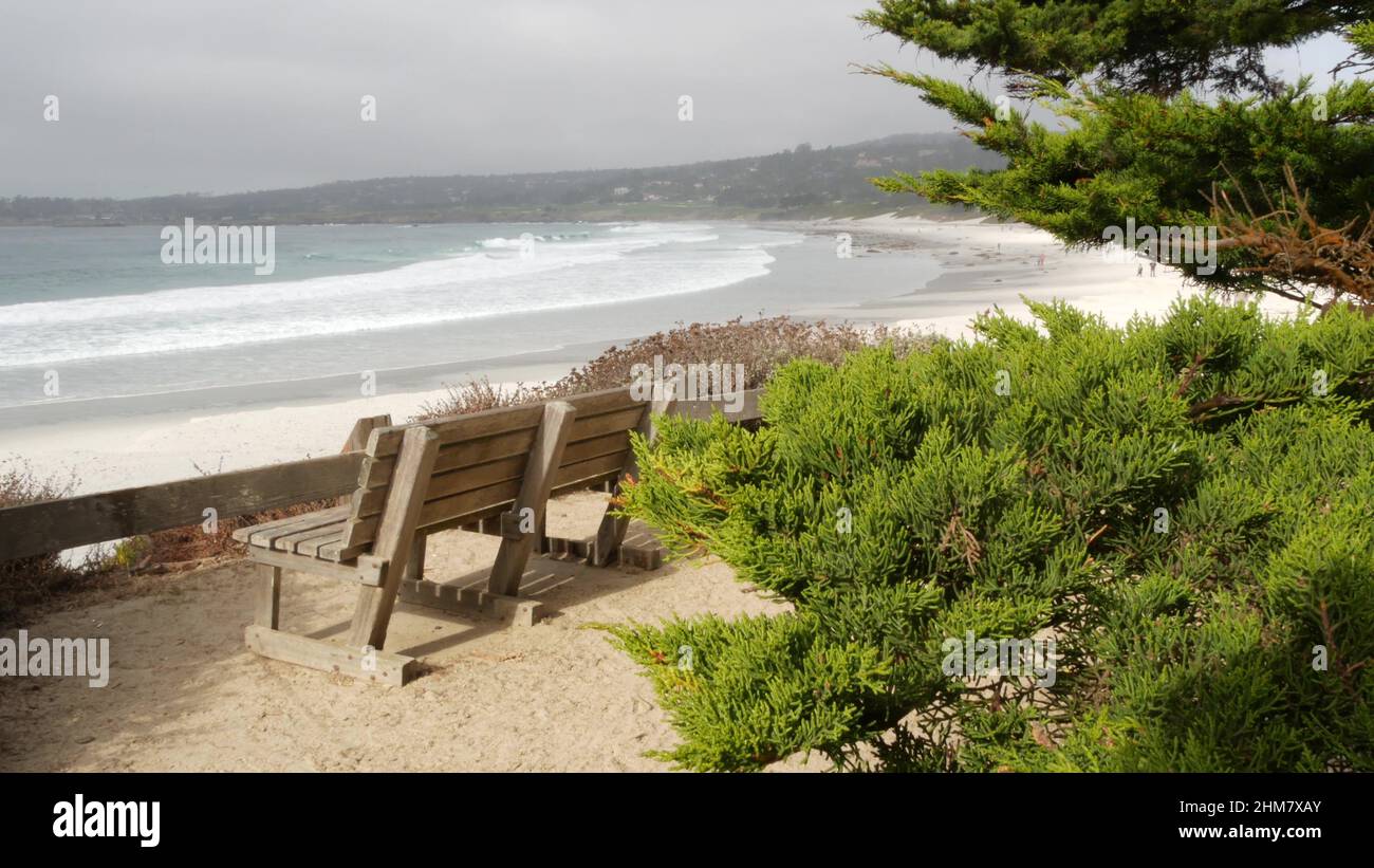 Empty wooden bench, rest on trail path, walkway or footpath. Carmel ...