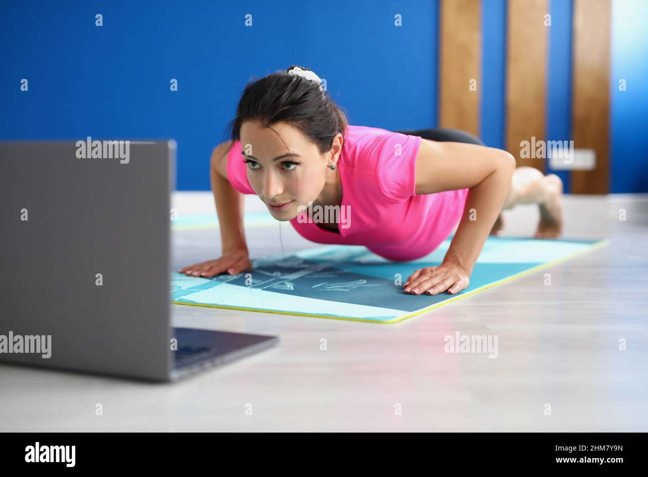 Low angle of concentrated woman exercise for full body, active train in ...