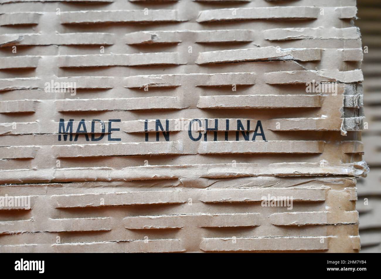 The inscription MADE IN CHINA on brown paper. Cardboard parcel filler ...