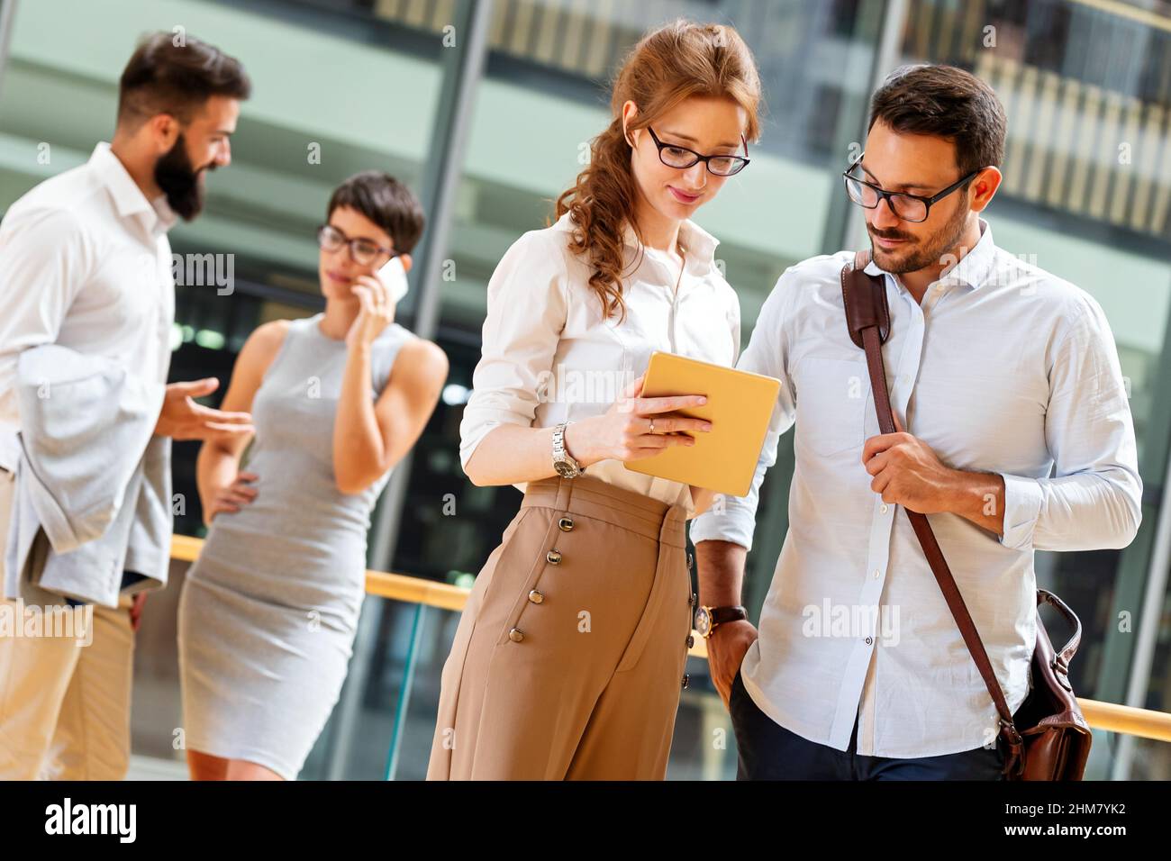 Group of business people walking outside in front of office buildings ...