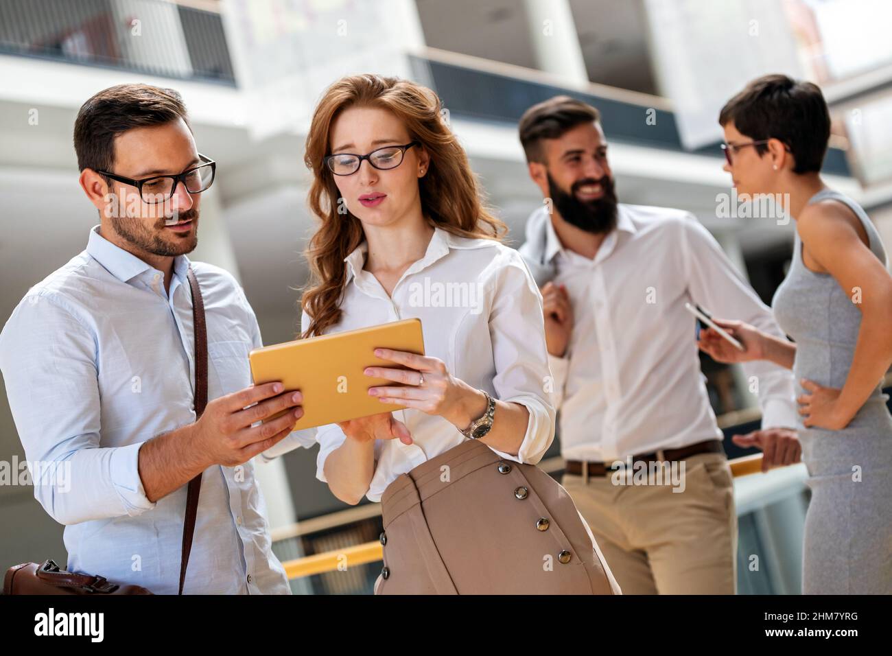 Business people having fun, teamwork and chatting at workplace office ...