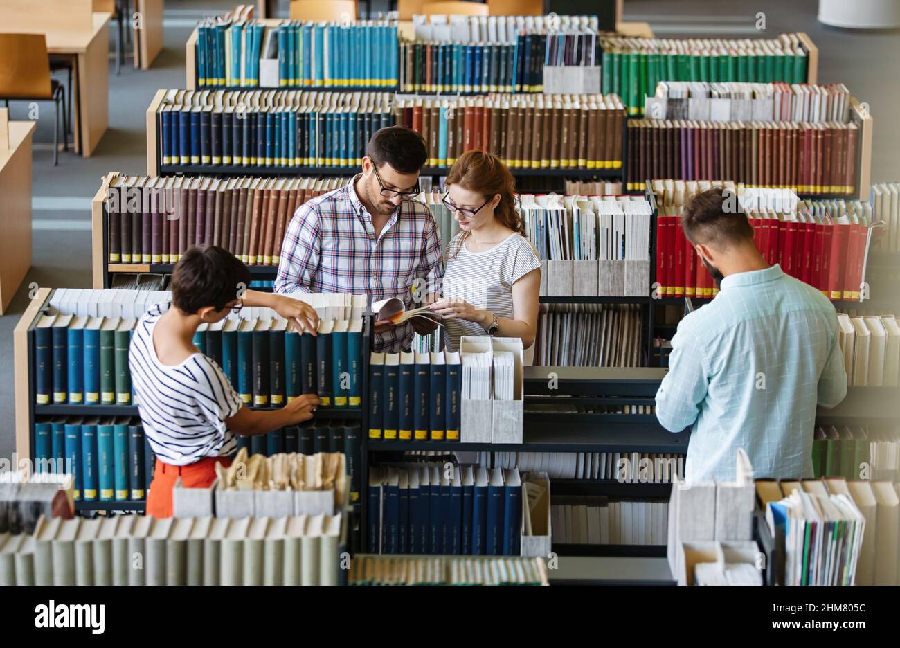 Happy group of students studying and working together in a college ...