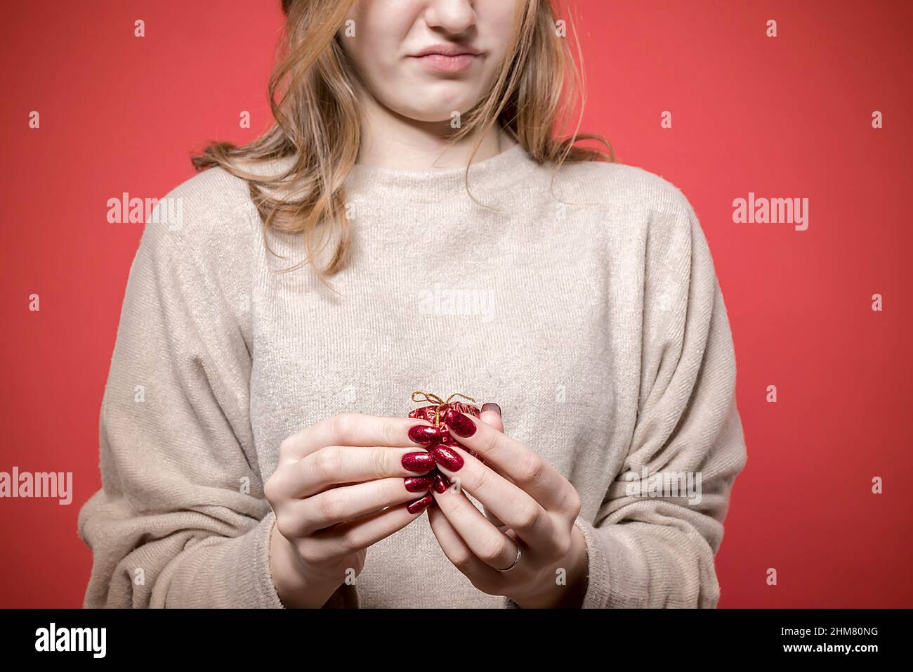 New year. Disgusting gift. Exchange of gifts. Girl frustrated holding a ...