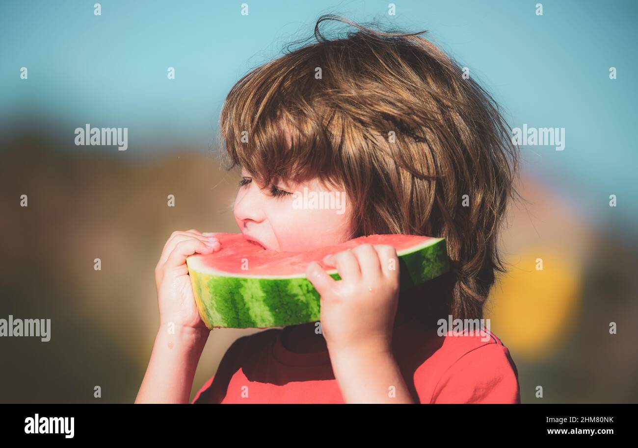 Kid eating watermelon outdoors. Healthy food for child Stock Photo - Alamy