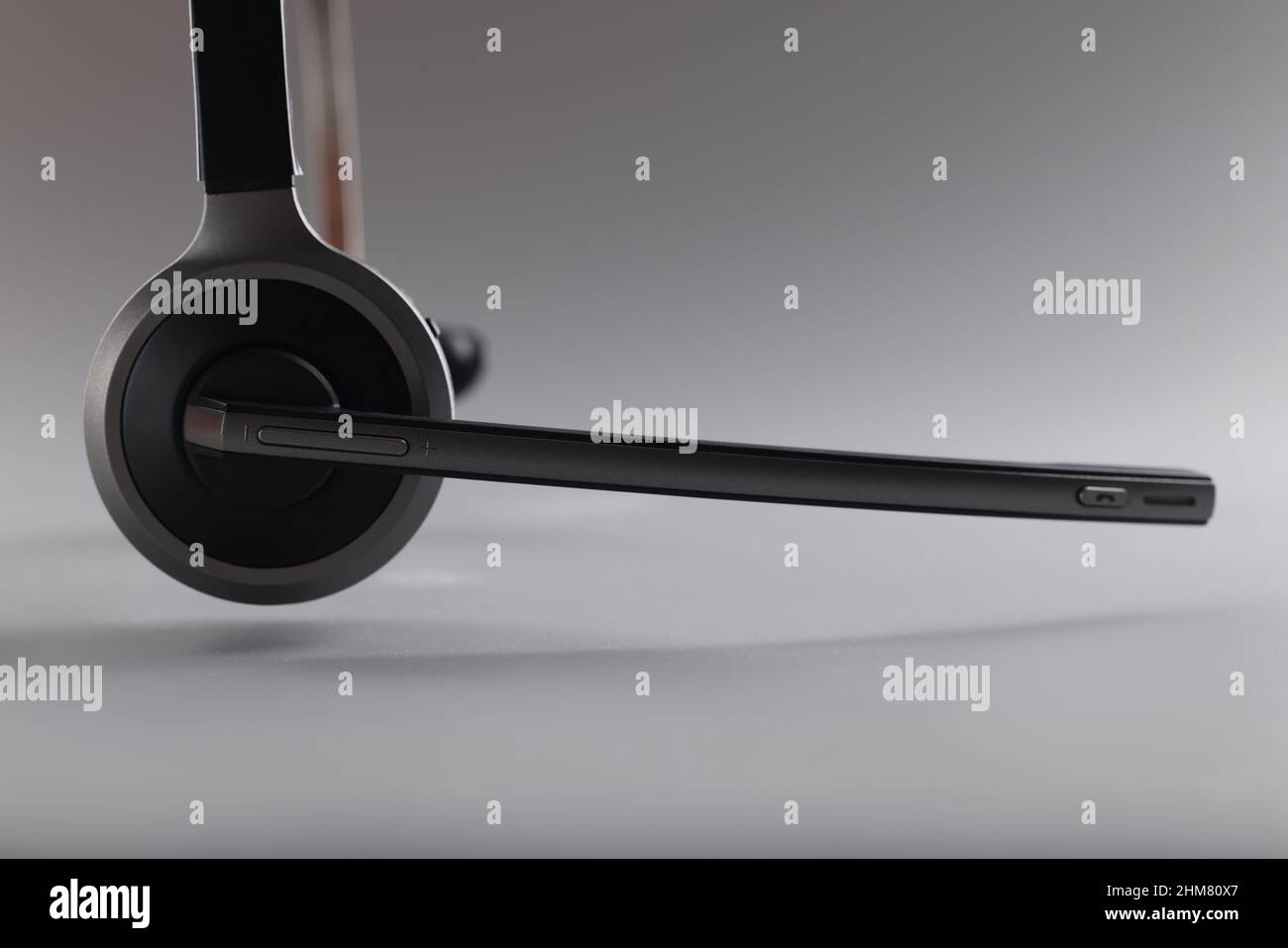 Headphones with microphone floating in air on grey background Stock ...