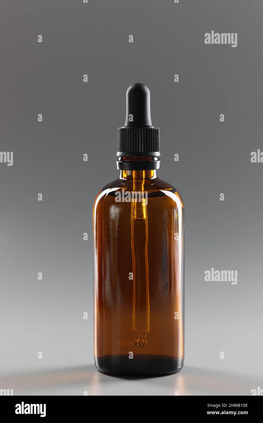 Brown glass bottle filled with oil, flask with cosmetology product or ...