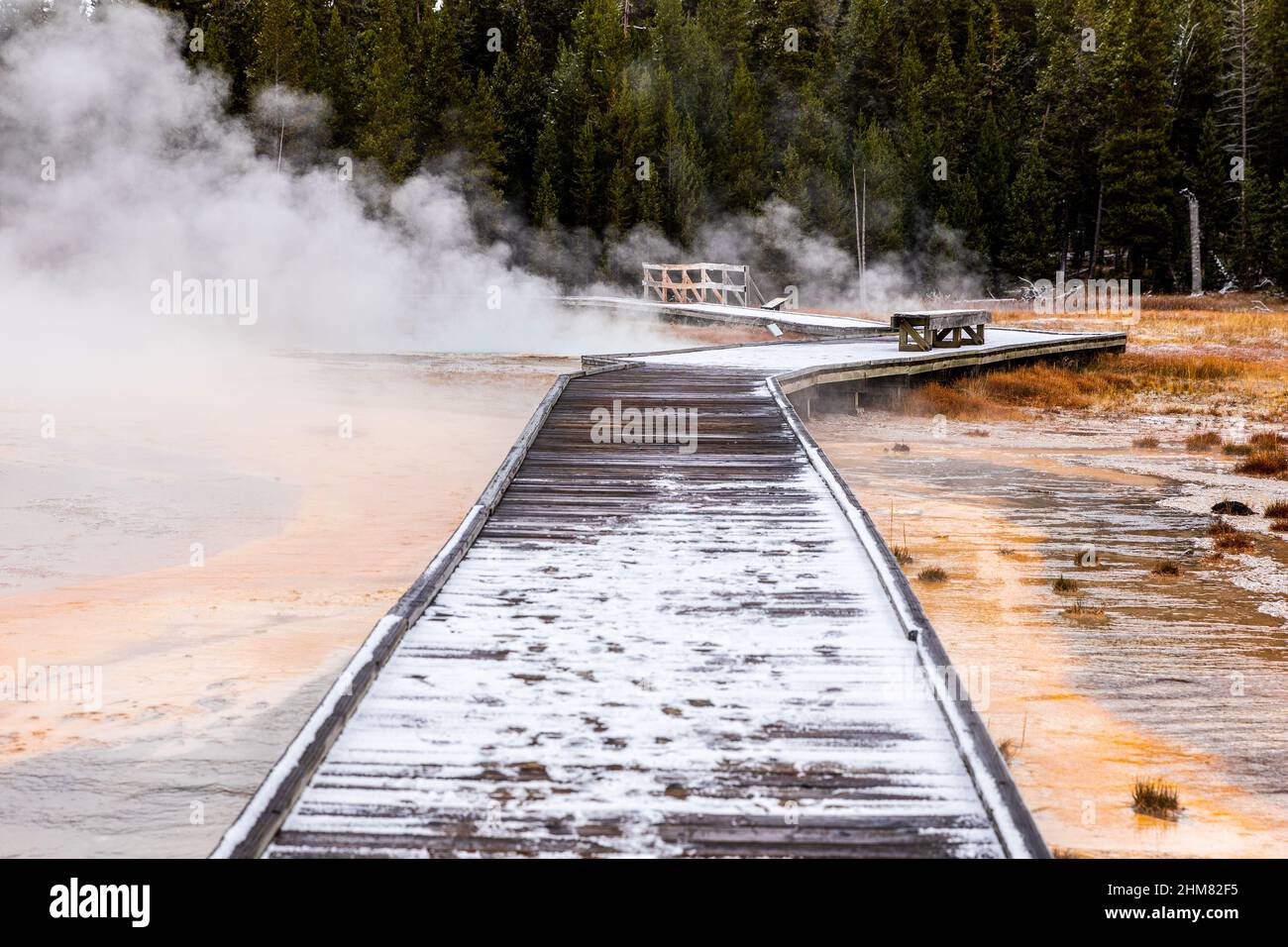Wooden walkway bridge for sightseeing covered by snow and tourist ...