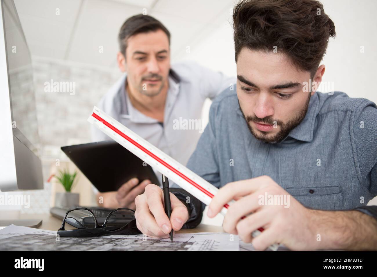 apprentice architect making blueprints using a scale ruler Stock Photo ...
