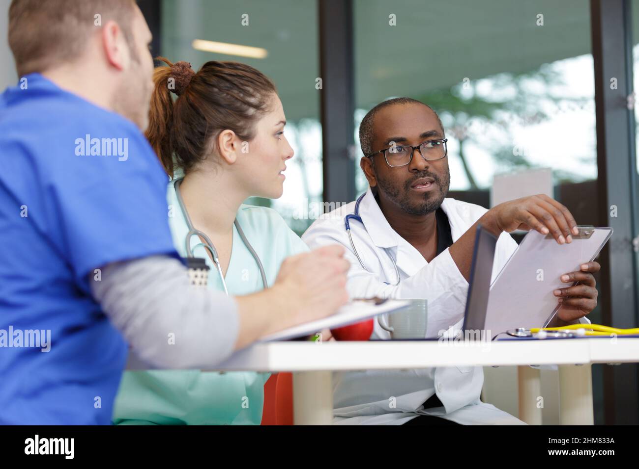 group of doctors involved in discussion at hospital Stock Photo - Alamy