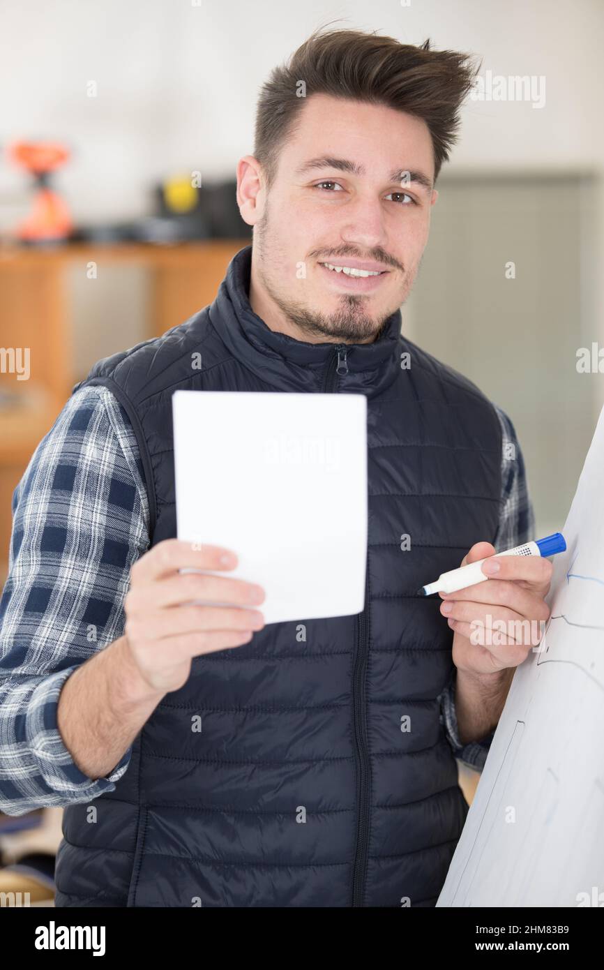 portrait of smiling worker holding blank billboard Stock Photo - Alamy