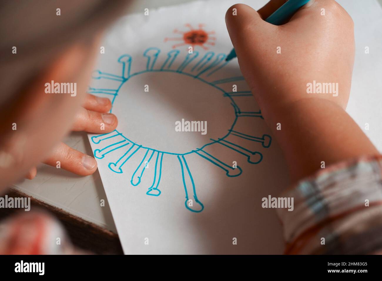 Cute little girl holds her drawing molecule Corona virus by felt tip ...