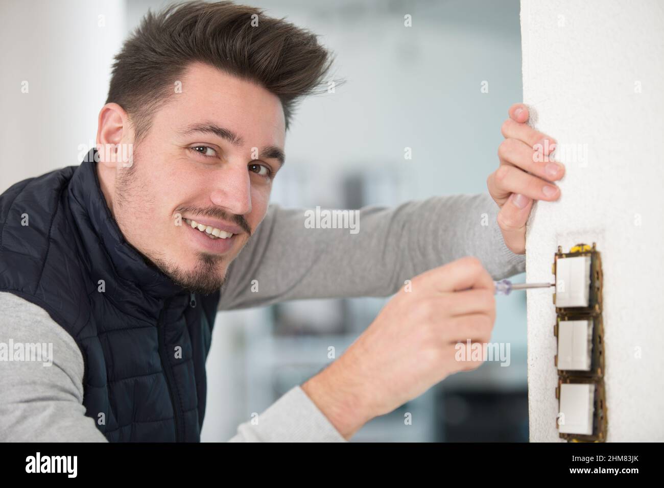 electrician fitting vertical switches Stock Photo - Alamy