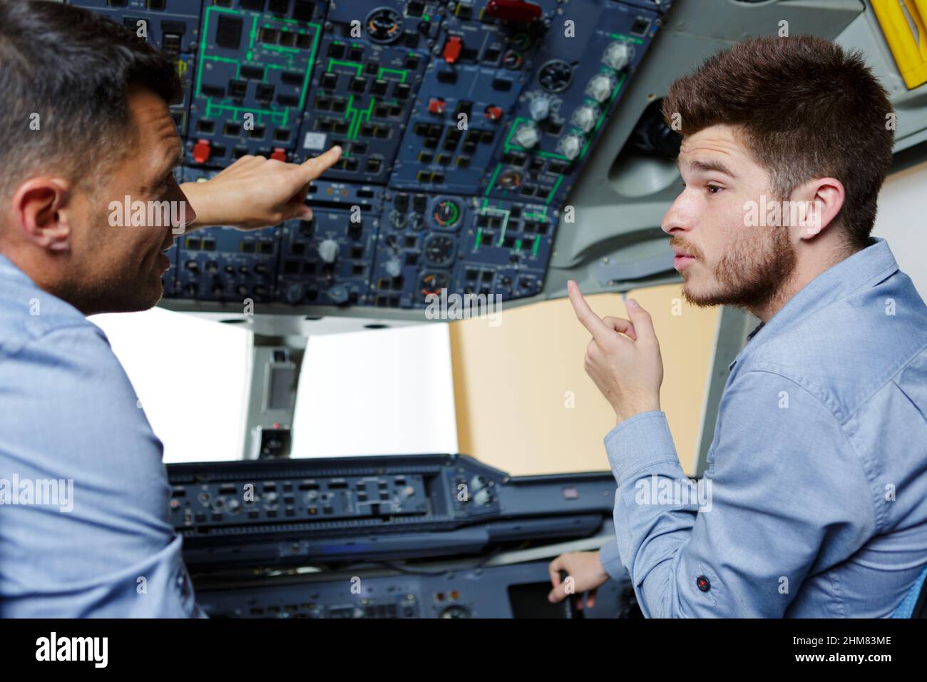 male aero engineer working in helicopter cockpit Stock Photo - Alamy