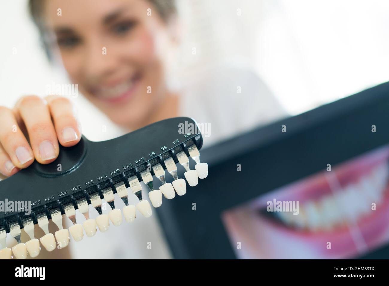 dentist checking and selecting colour of the teeth Stock Photo - Alamy