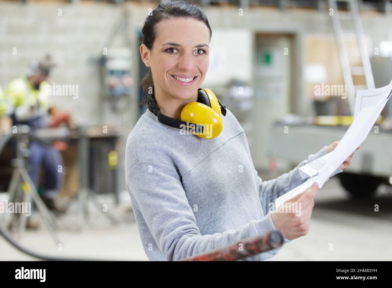 happy female metalworker meeting in factory Stock Photo - Alamy