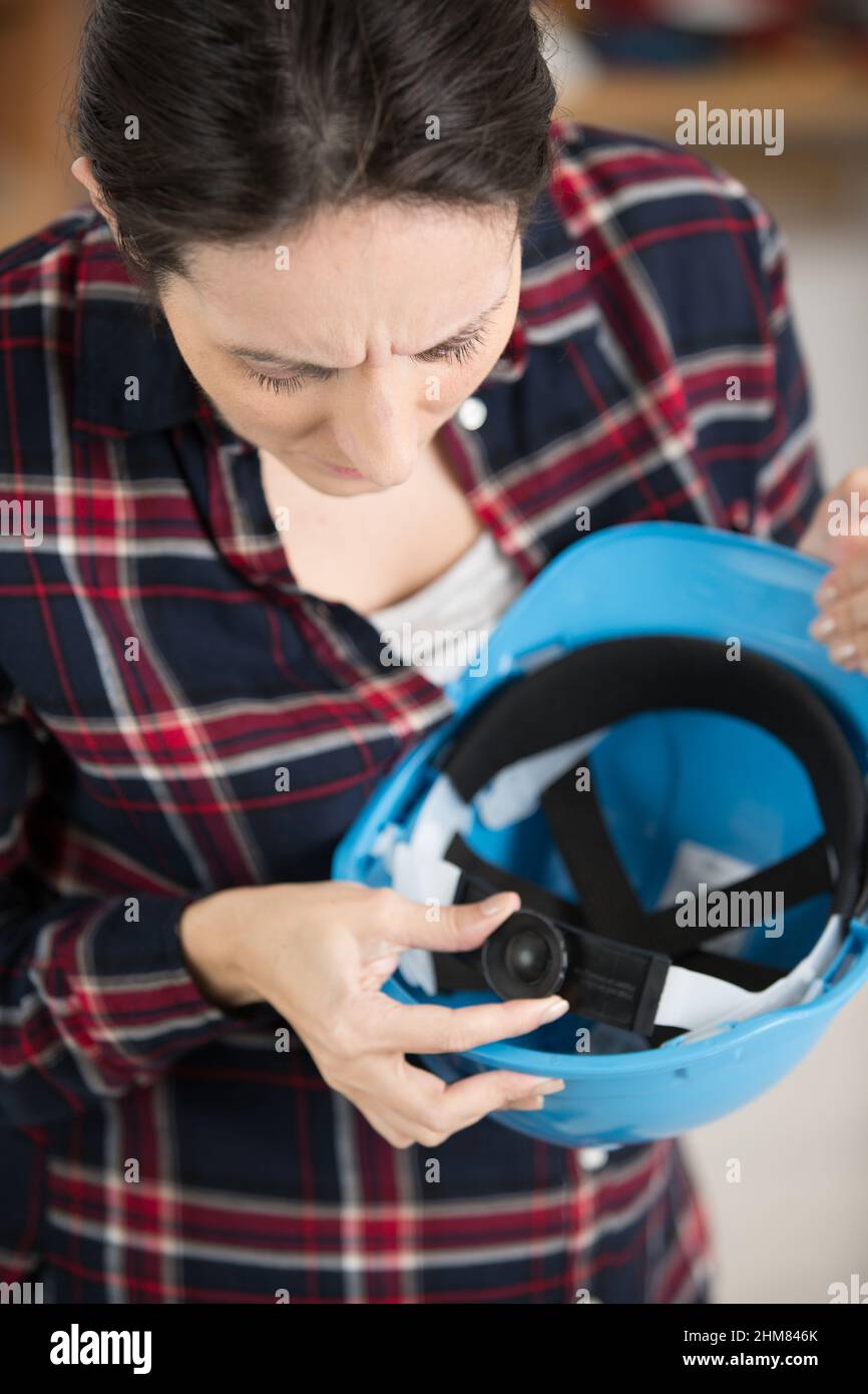 woman adjusting the size of a helmet Stock Photo - Alamy