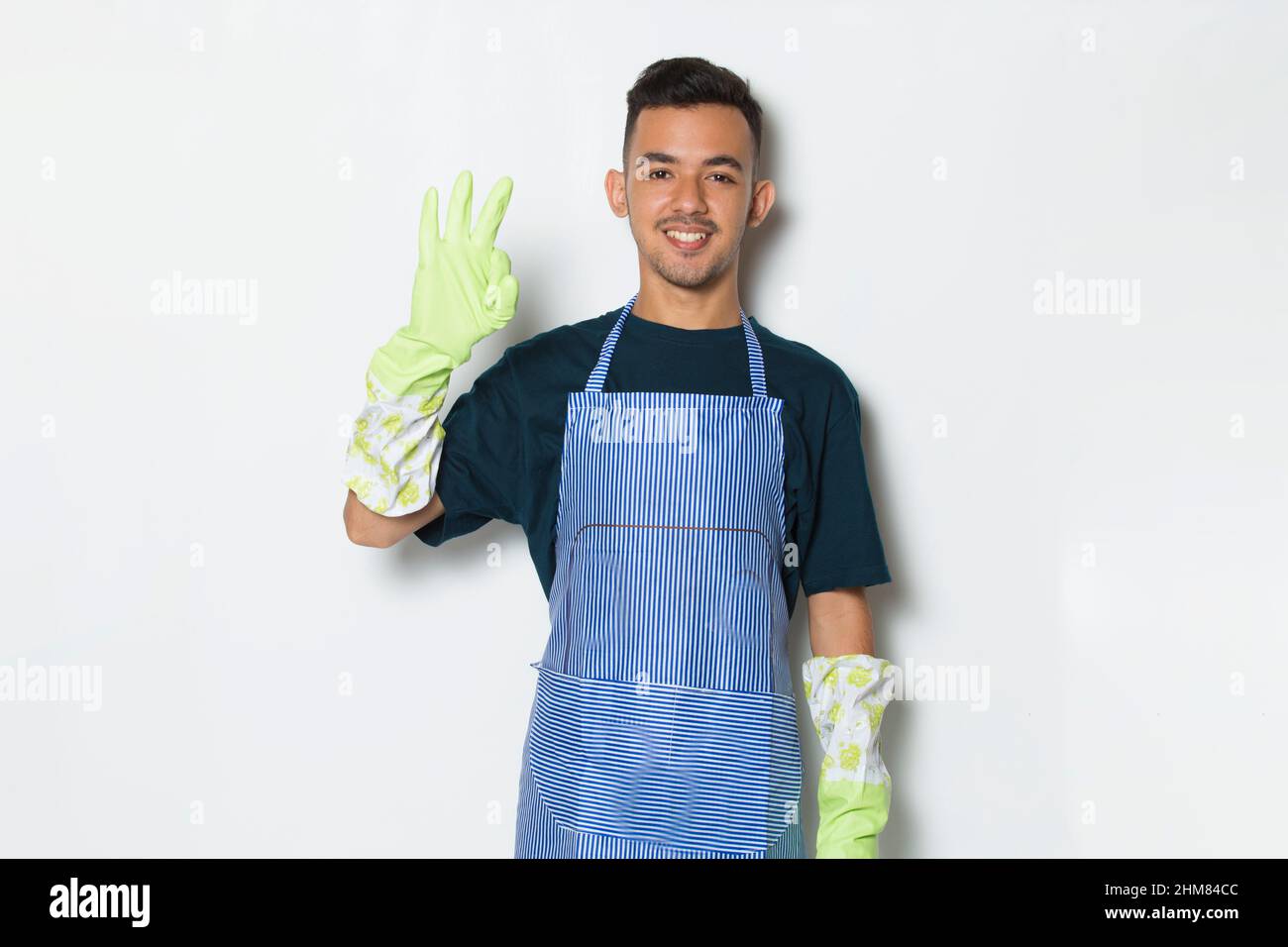 Cleaner man Showing Thumb Up Sign Over White Background Stock Photo - Alamy