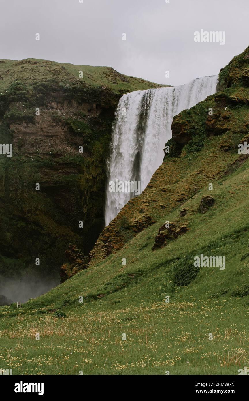 Natural view of the Skougafoss waterfall in Iceland under a gloomy sky ...