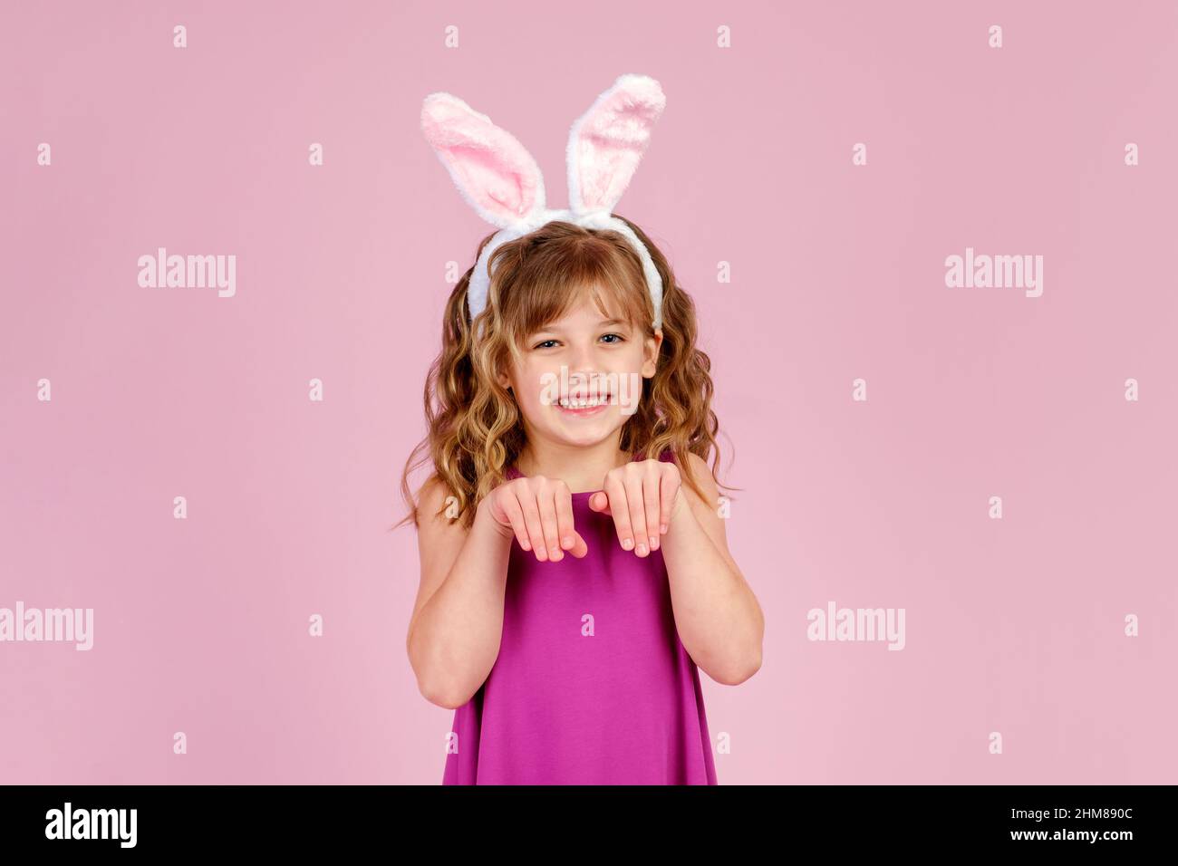 Cute little girl acting like rabbit during Easter celebration Stock ...