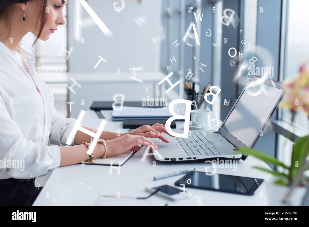 Attractive female assistant working, typing, using portable computer ...