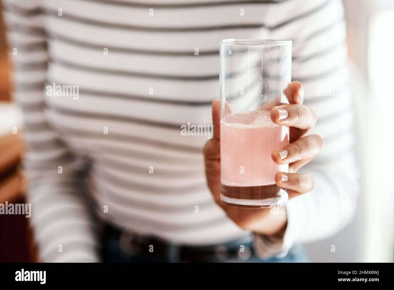 Get a good dose of health in a glass. Cropped shot of a woman having an ...