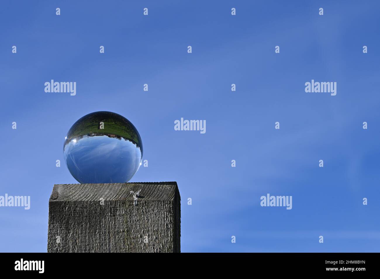 Environment concept, a crystal ball sitting on a fence post, reflection ...