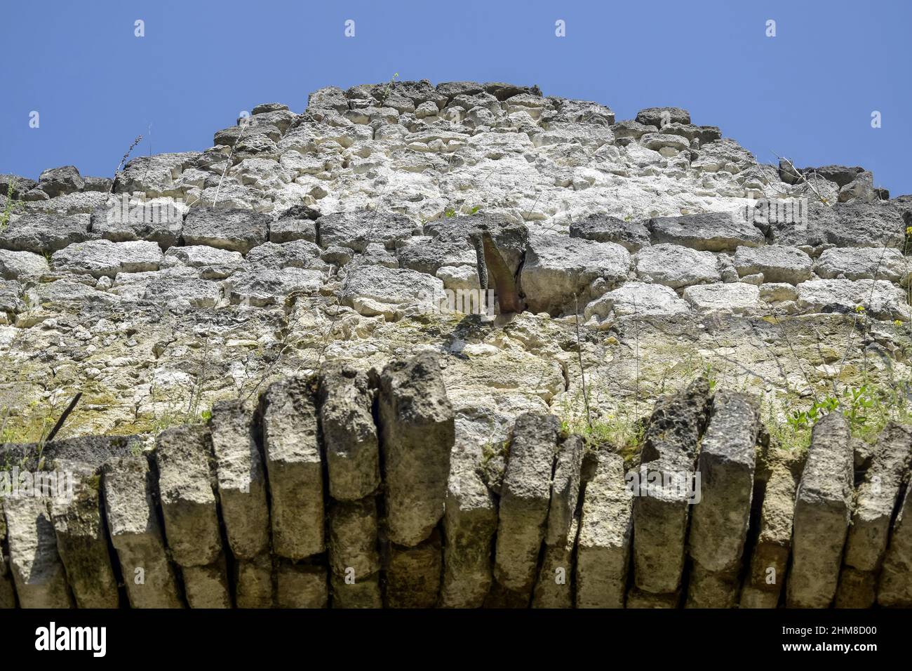 Ruined roof of an ancient building against clear sky. Remains of arch ...