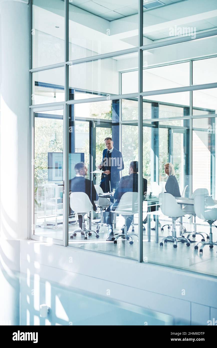 Getting their meeting up and running. Full length shot of a group of ...