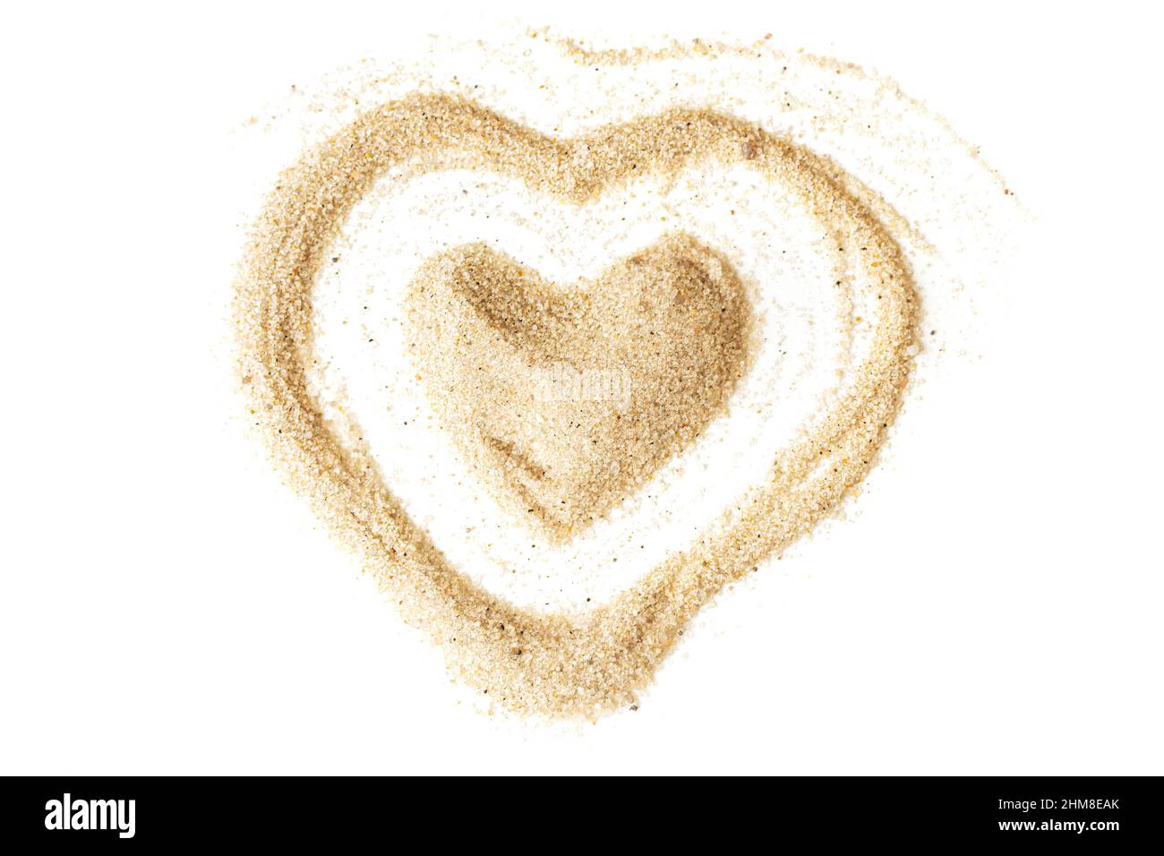 Heart shapes made of sand on a white table background Stock Photo - Alamy