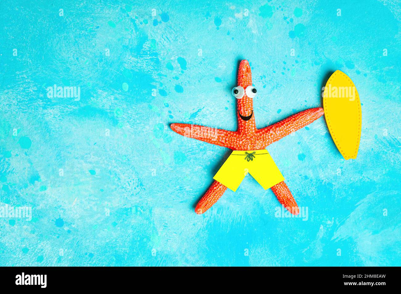 Funny starfish character with a yellow surfboard lying on a light blue ...