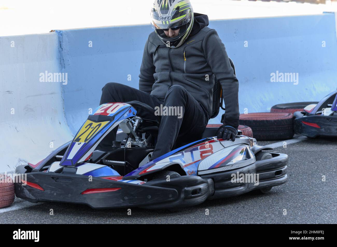 Man in pits reading for Go-carts race on karting track Stock Photo - Alamy