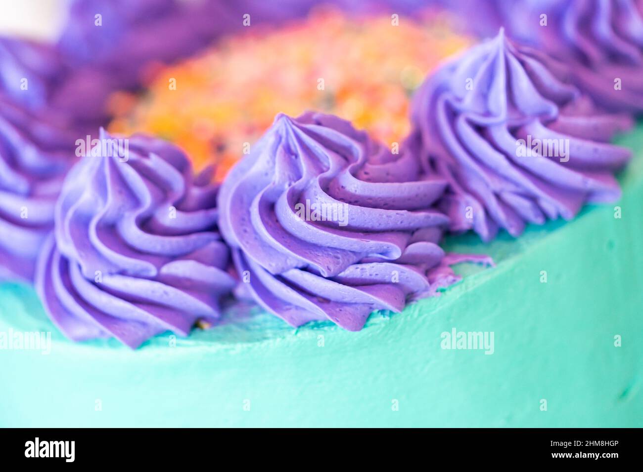 Birthday cake with turquoise buttercream and purple rosettes and ...