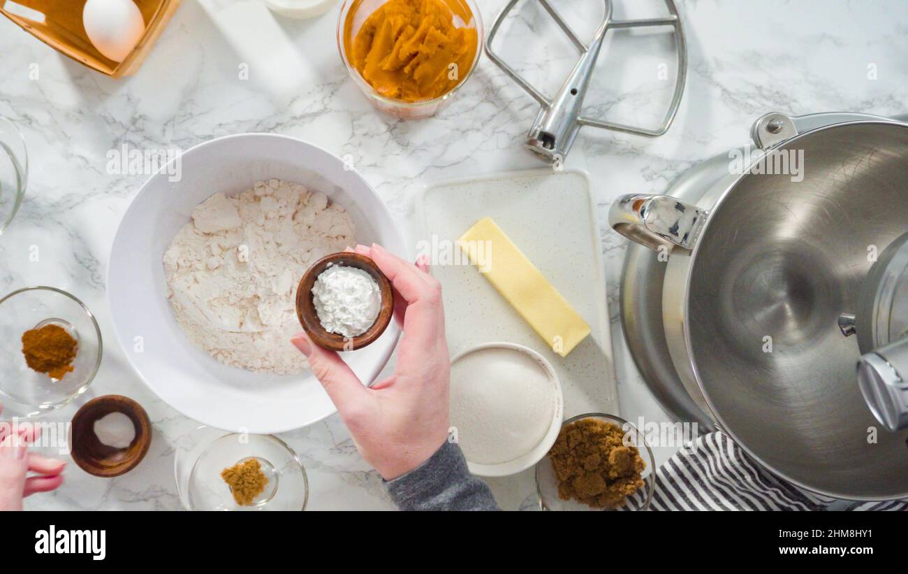 Flat lay. Mixing ingredients in electric kitchen mixer to bake pumpkin ...