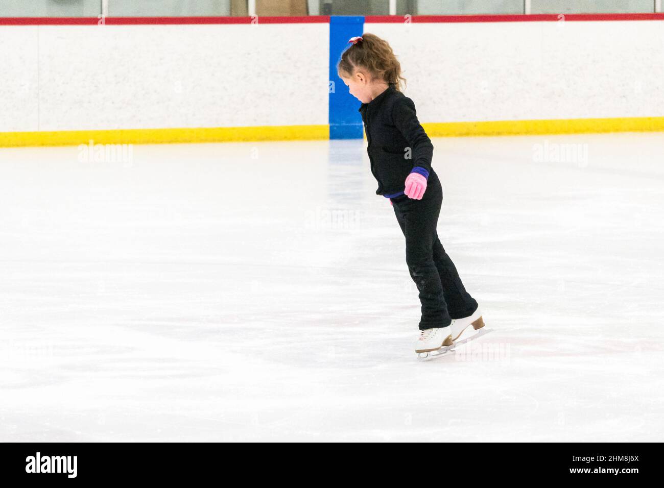 Little skater practicing her elements at the morning figure skating ...
