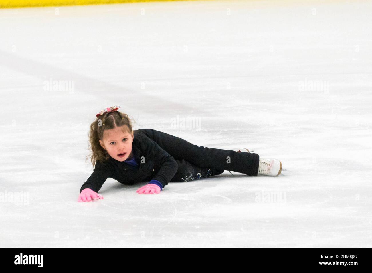 Little skater practicing her elements at the morning figure skating ...