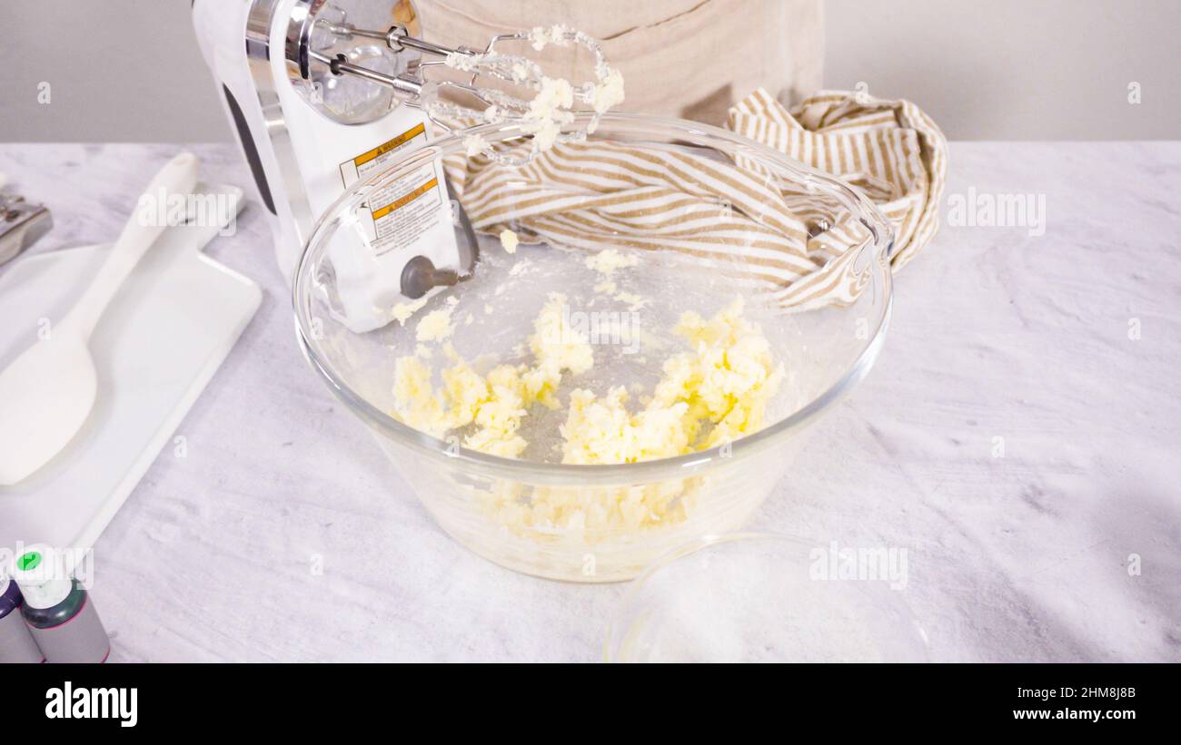 Step by step. Mixing ingredient in a mixing bowl with an electric mixer ...