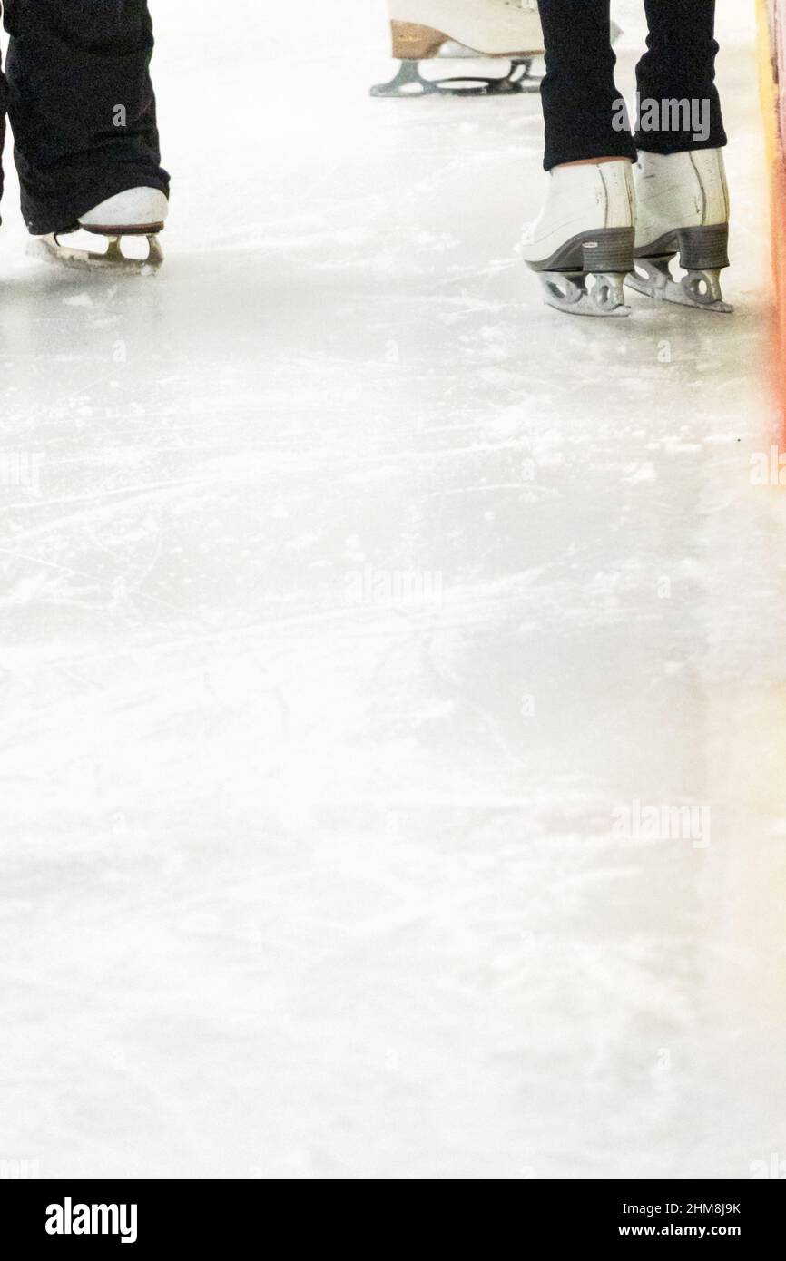 View of a figure skater and her coach feet at the figure skating ...