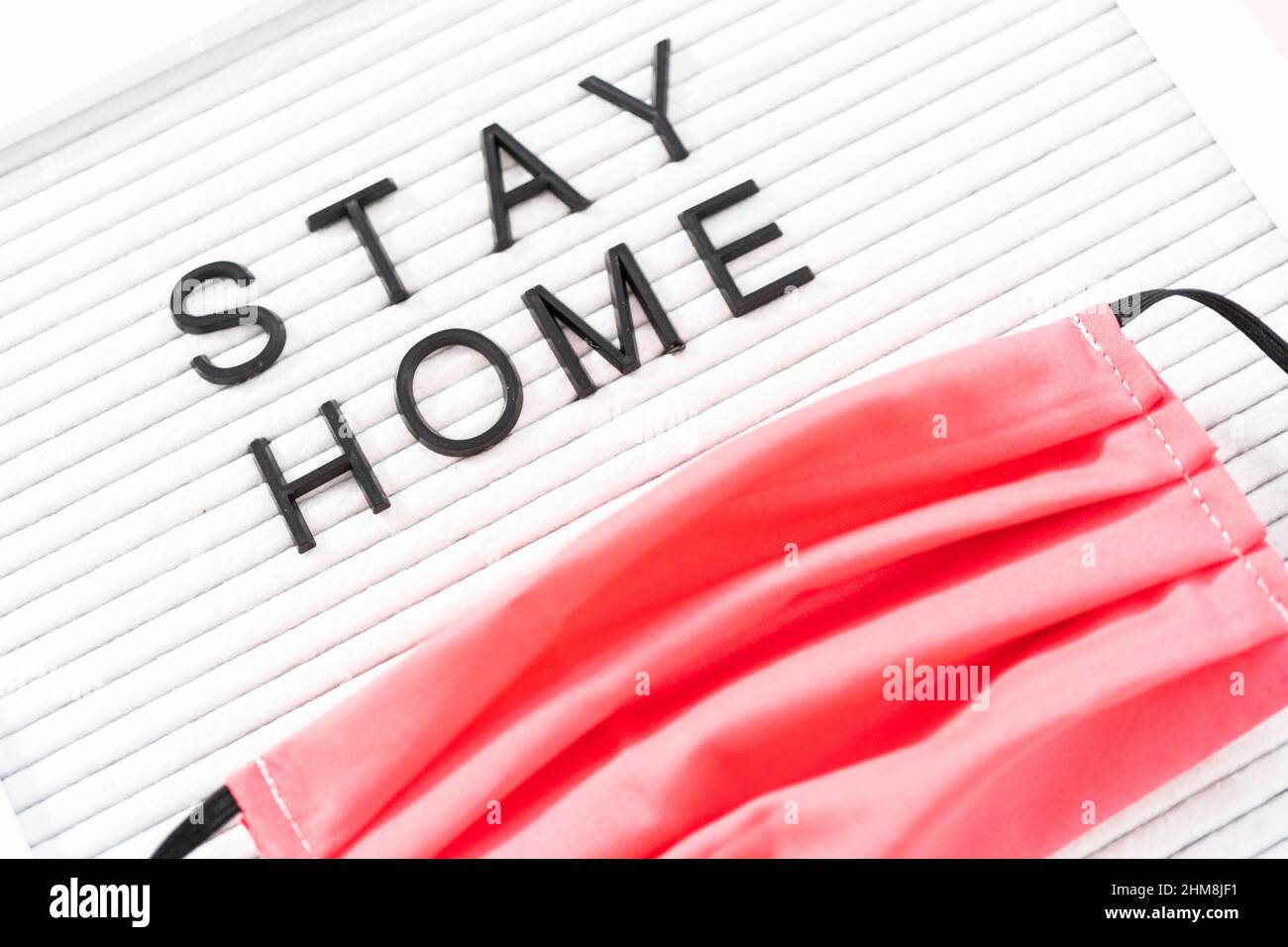 STAY HOME sign on message board with a homemade face mask Stock Photo ...