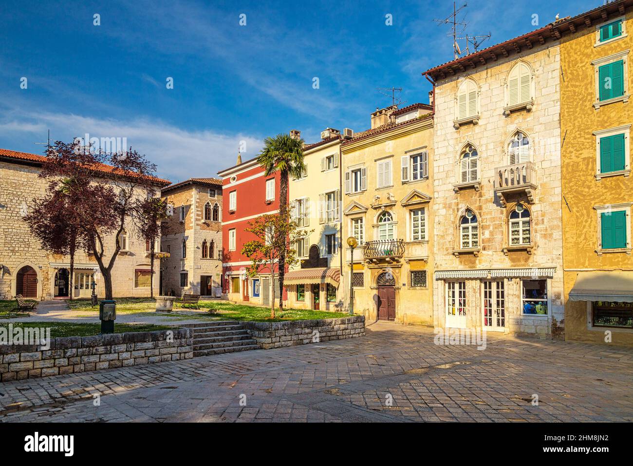 Town square with colorful facade of an old houses in Porec, Croatia ...